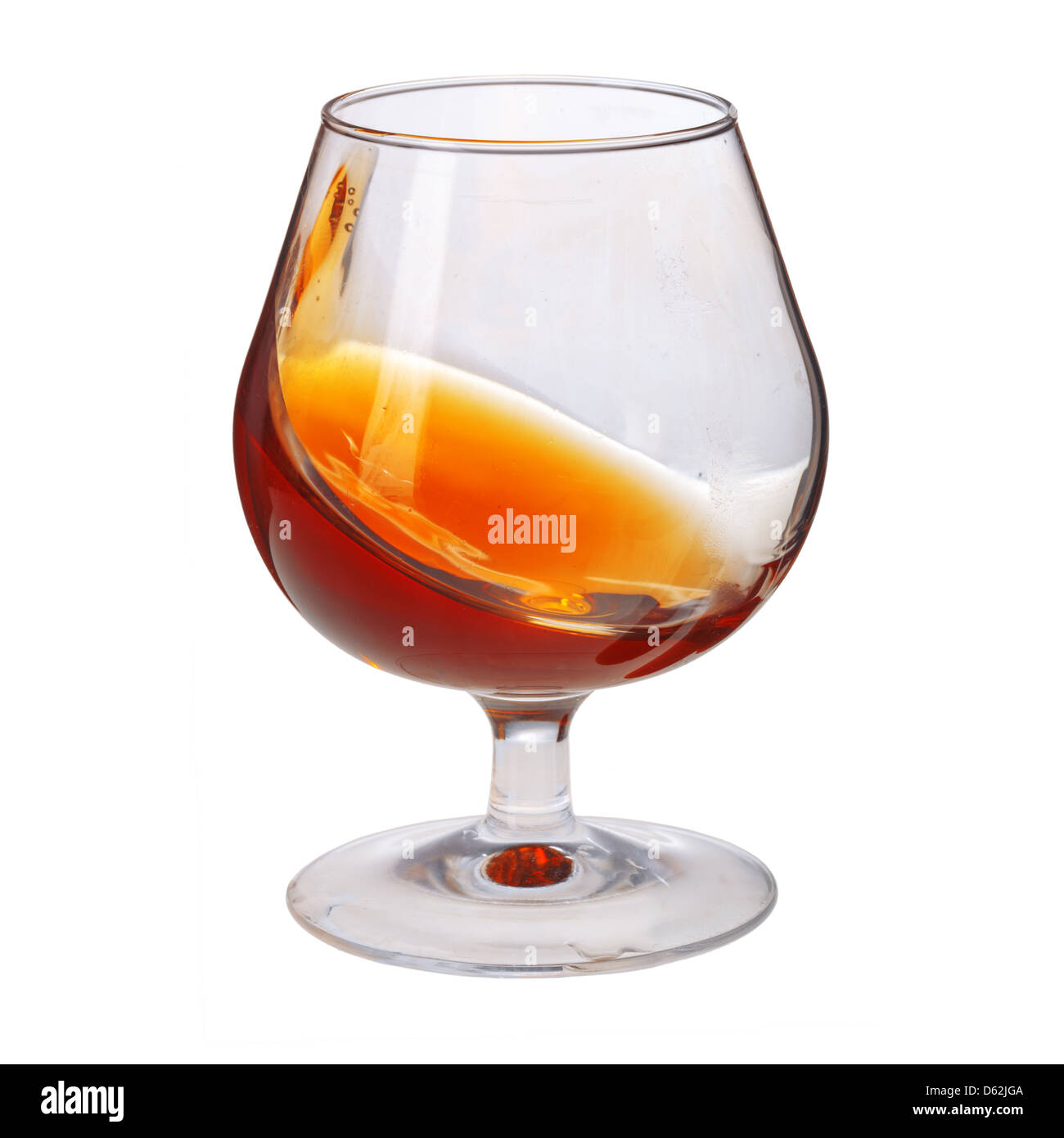 Splash of cognac in glass on white background Stock Photo - Alamy