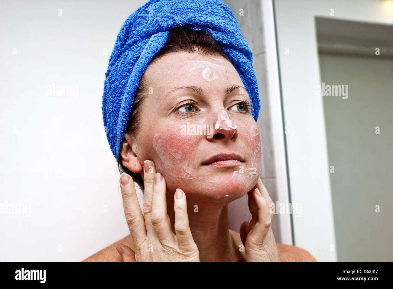 Woman smears face cream Stock Photo - Alamy
