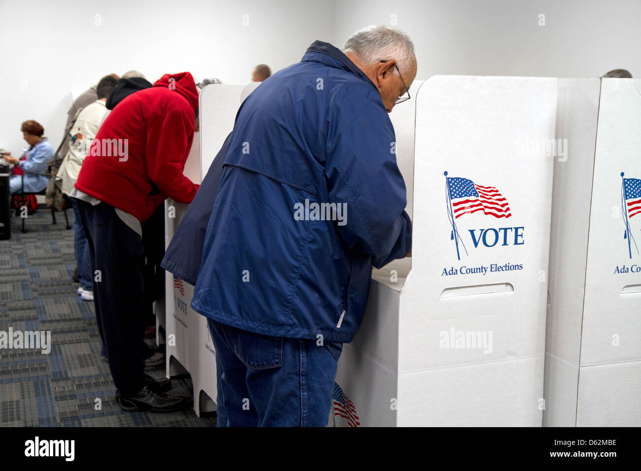 People vote in cardboard voting booths at a polling station in Boise ...