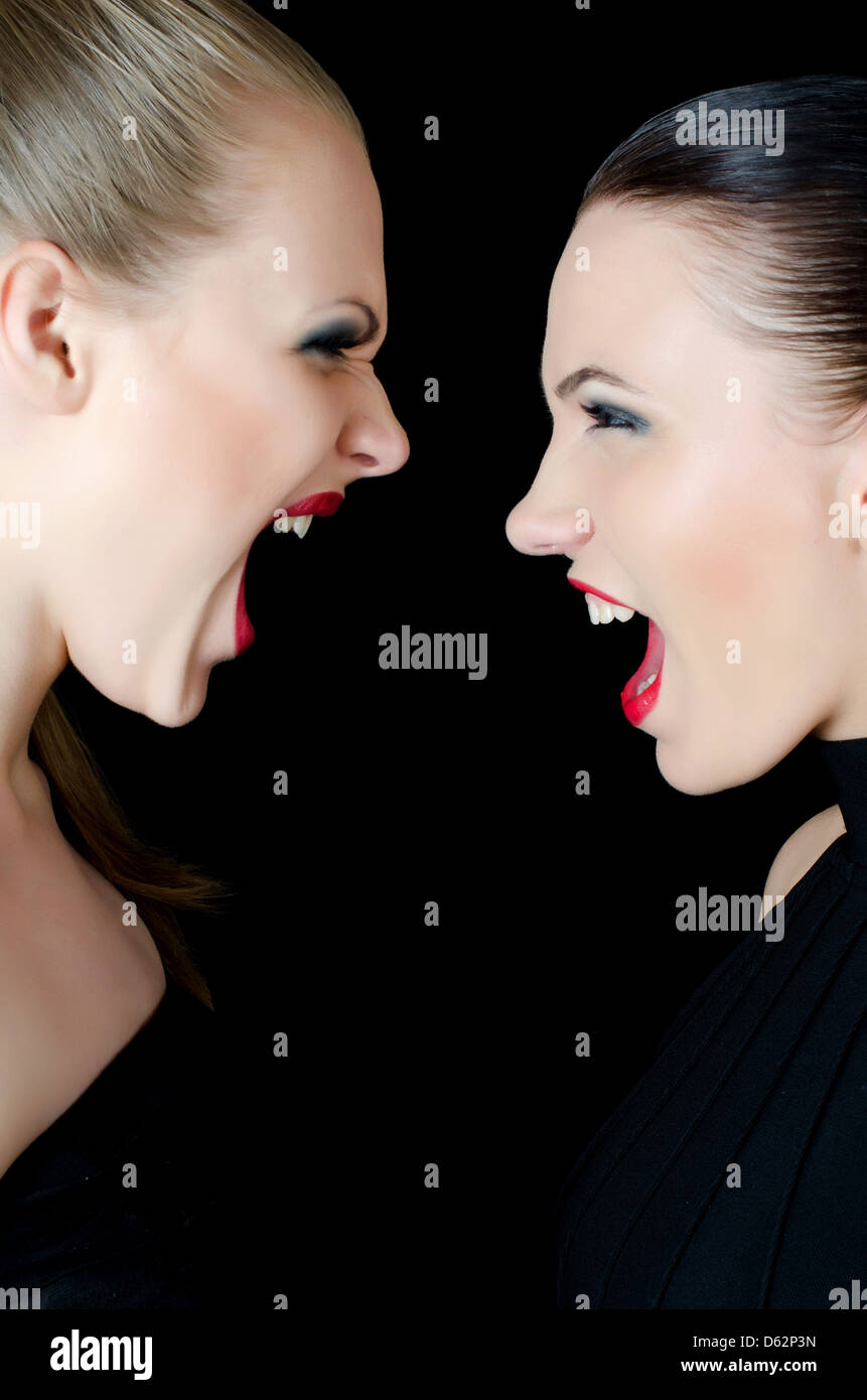 Two beautiful girls shout and swear Stock Photo - Alamy