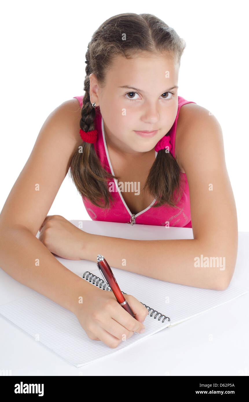 The young girl writes to writing-books Stock Photo - Alamy