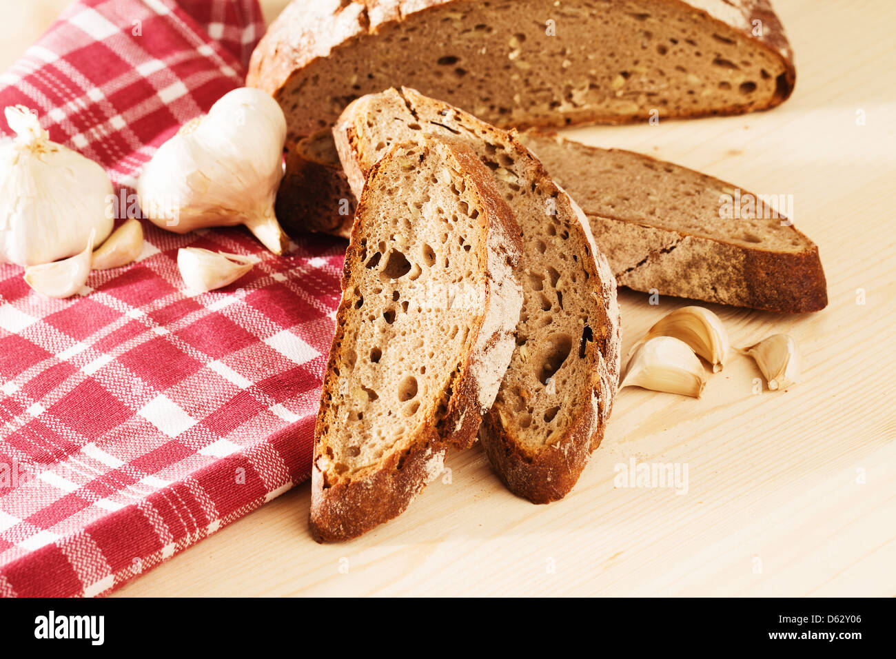 rye bread with garlic and a towel on wooden background Stock Photo - Alamy