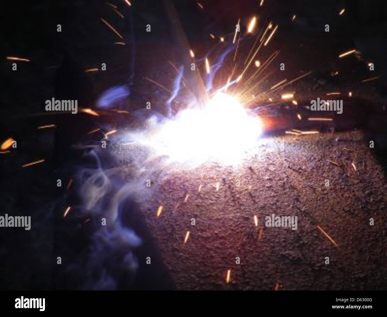 A manual metal arc welding process in action, showing a bright UV arc ...