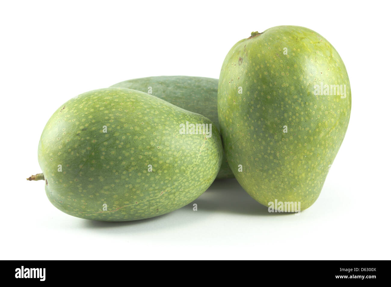 Three green mangoes isolated on white background Stock Photo - Alamy