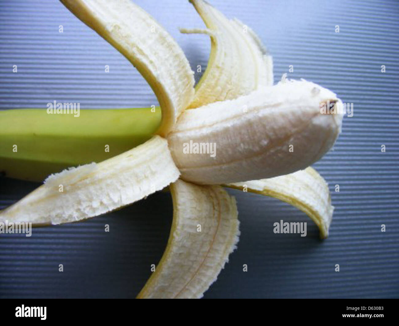 A peeled banana showing the soft, yellow flesh inside. The image ...