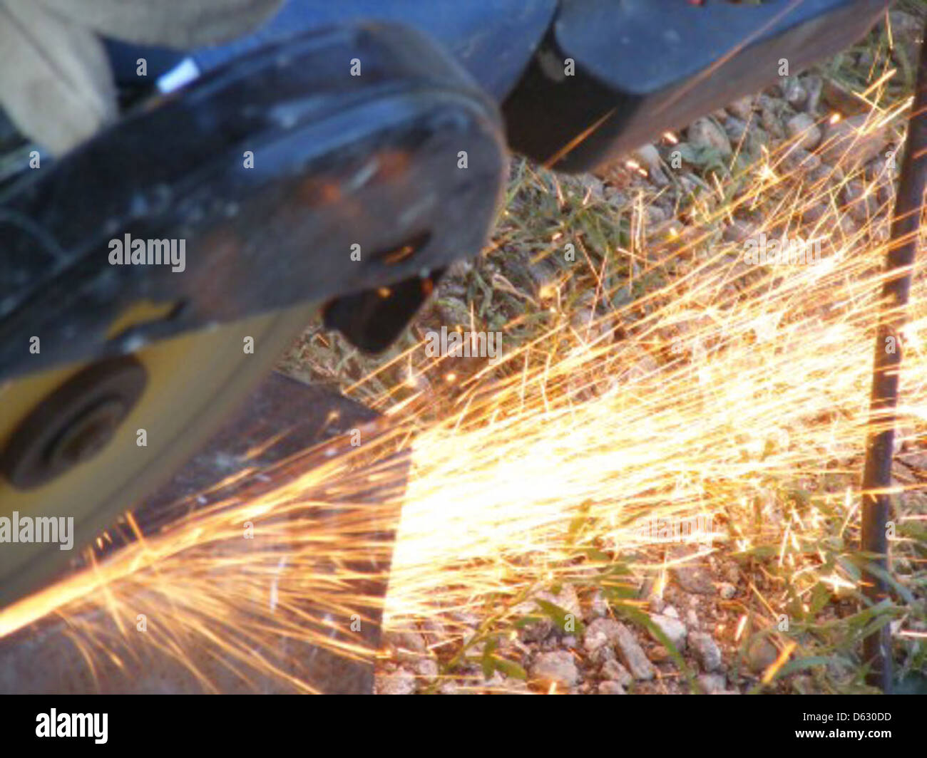This image captures the sparks flying from an angle grinder during use ...