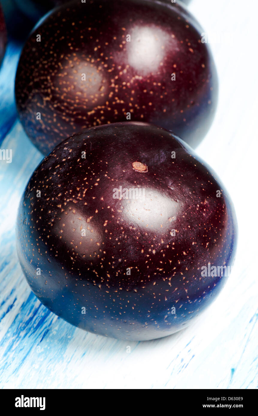 Two plums on table Stock Photo - Alamy
