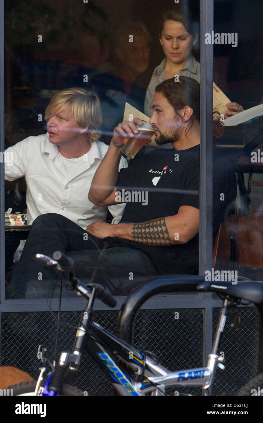 Jason Momoa enjoys a drink whilst having lunch with friends at a ...