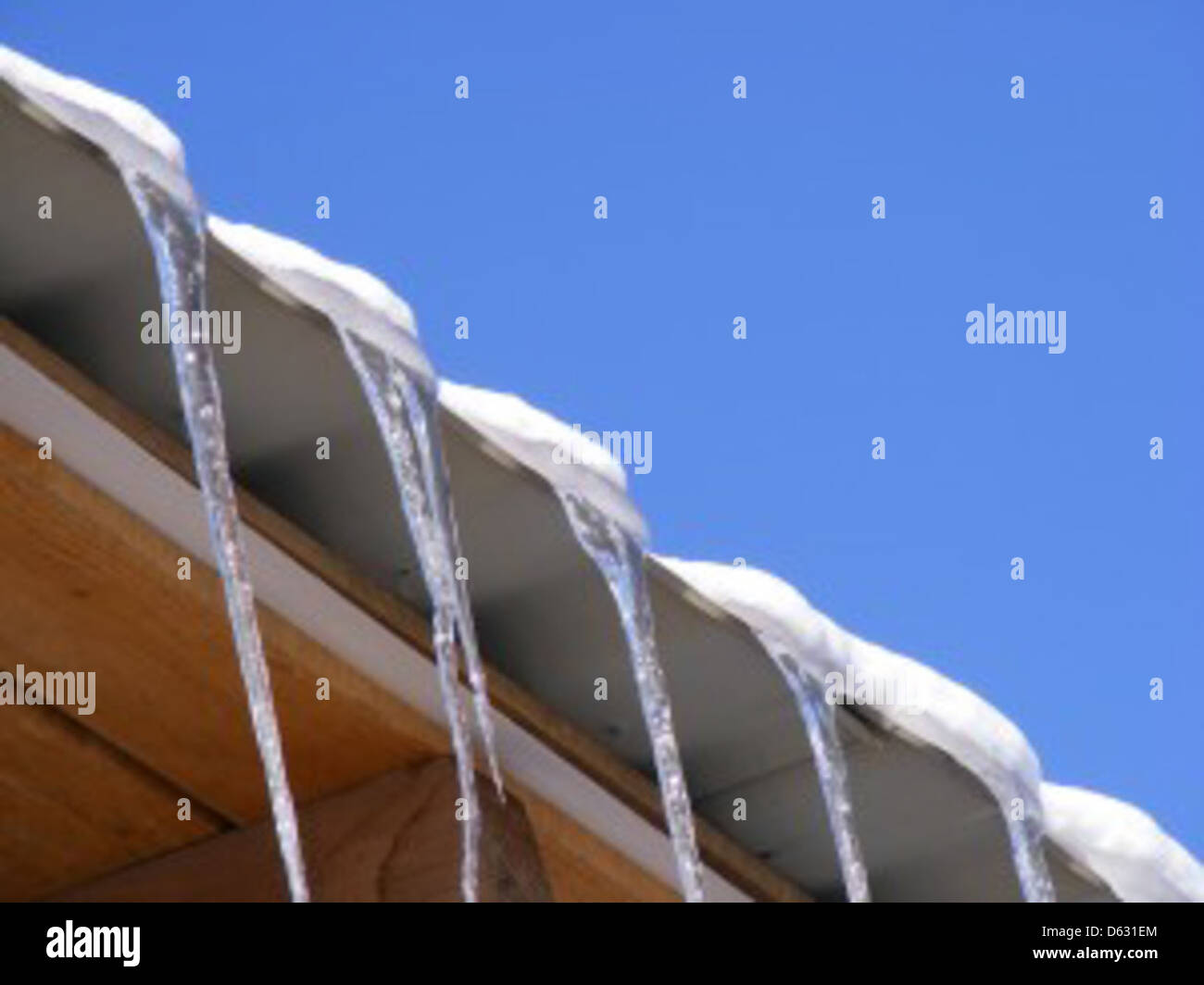 A close-up of ice dams forming on a roof during the winter season ...