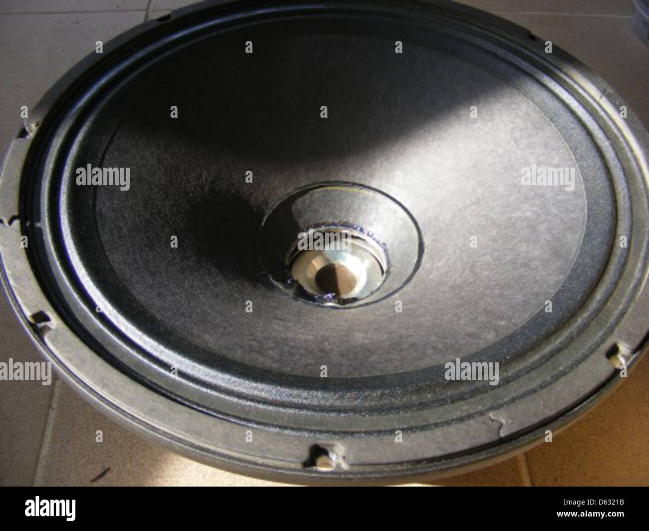 This image features a damaged Electro-Voice professional loudspeaker ...
