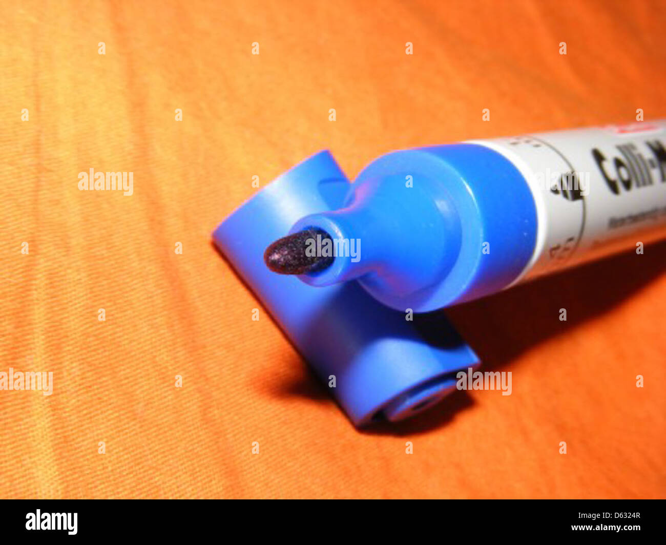 A close-up of a blue permanent marker, used for writing on various ...