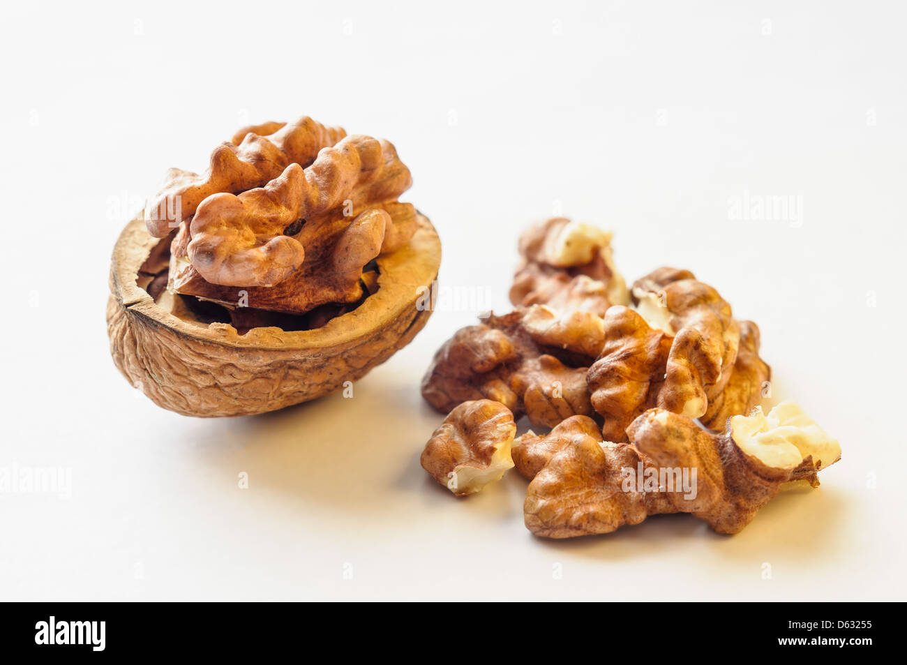 A close up of an open walnut on white background Stock Photo - Alamy