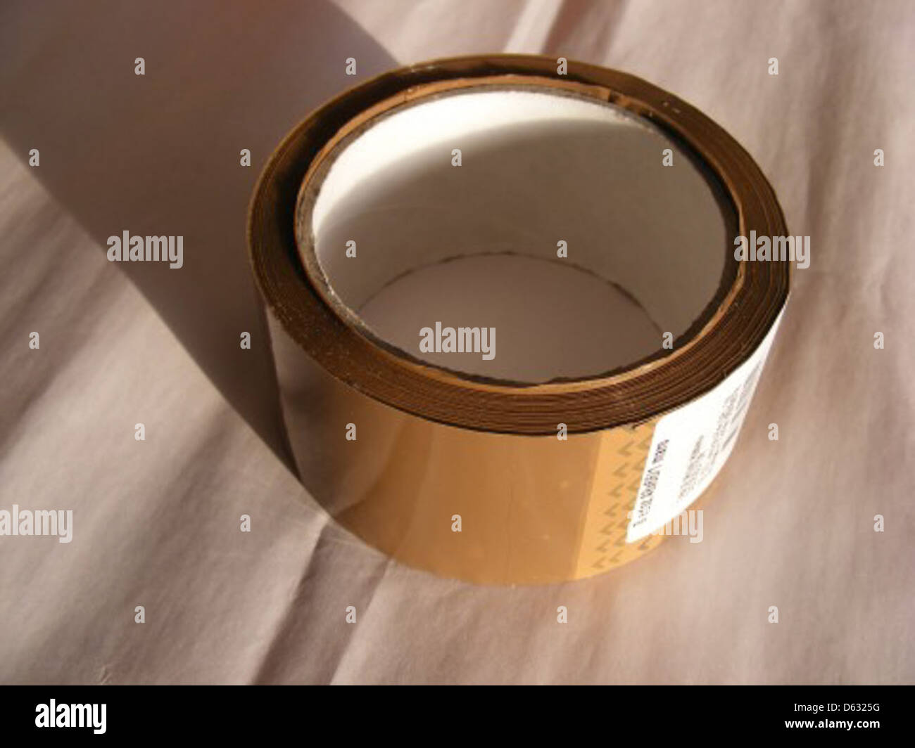 A roll of brown packaging tape, commonly used for sealing boxes and ...