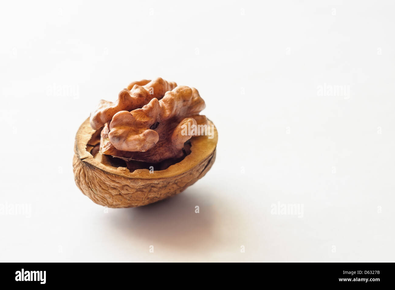 A close up of an open walnut on white background Stock Photo - Alamy