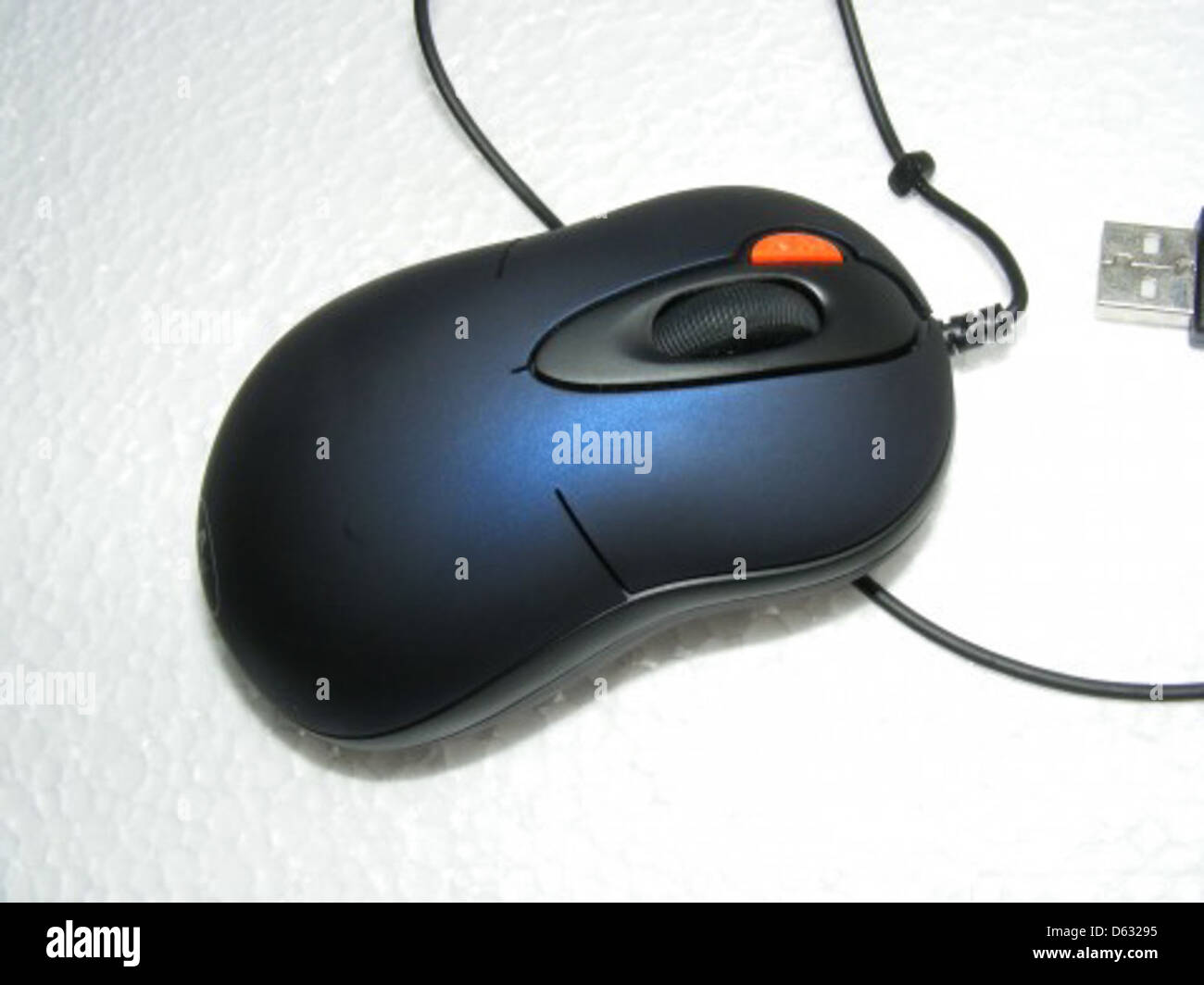 An image showing a notebook computer with a mouse and blue cards. The ...