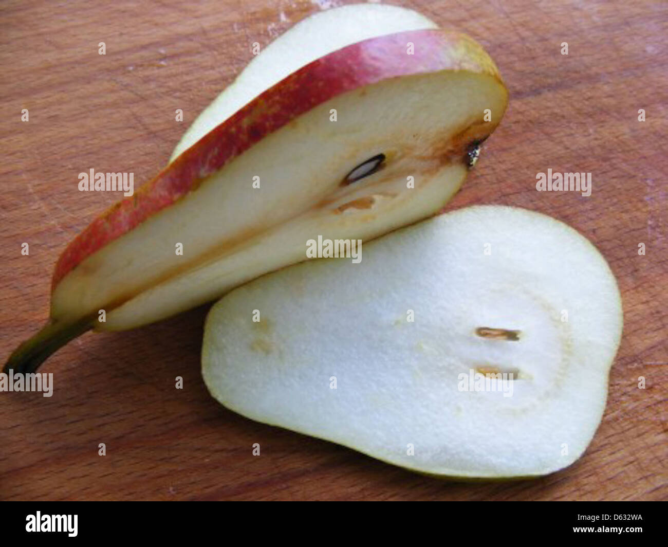 A fresh, sliced pear showing its smooth, juicy interior. The pear is a ...