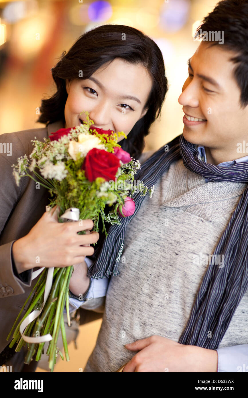 Young couple with flowers Stock Photo - Alamy