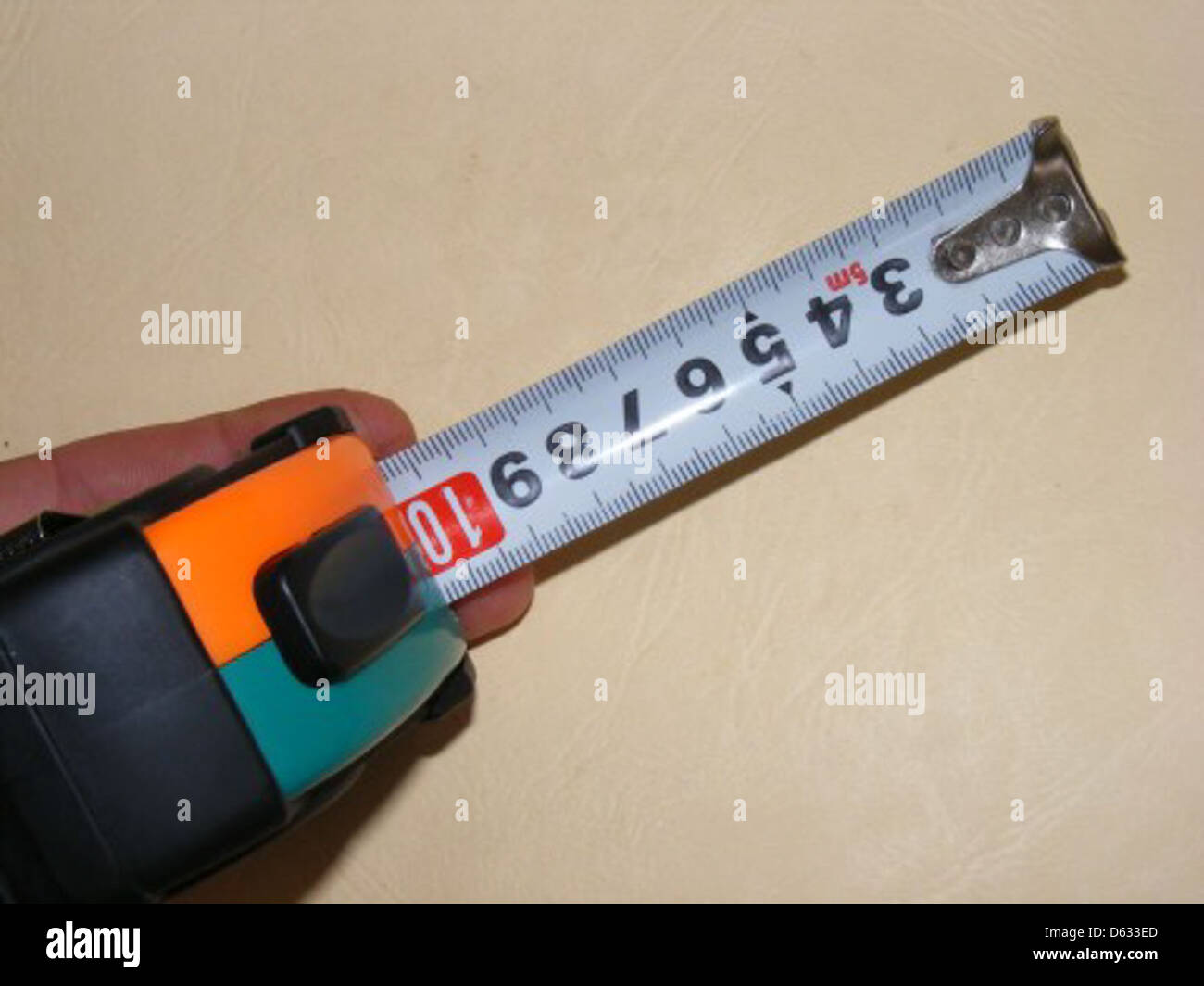 A power tape measure, used in construction and renovation, designed for ...