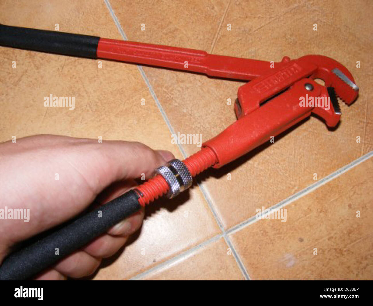 This image features a double-handle pipe wrench, a common tool used in ...