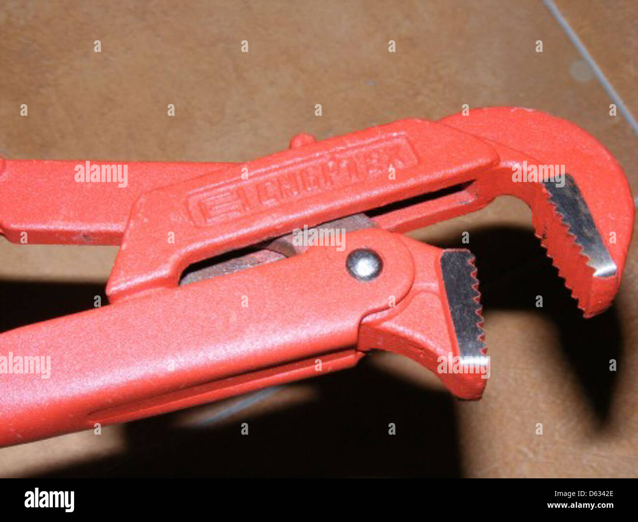 This image features a double-handle pipe wrench used for repairing ...