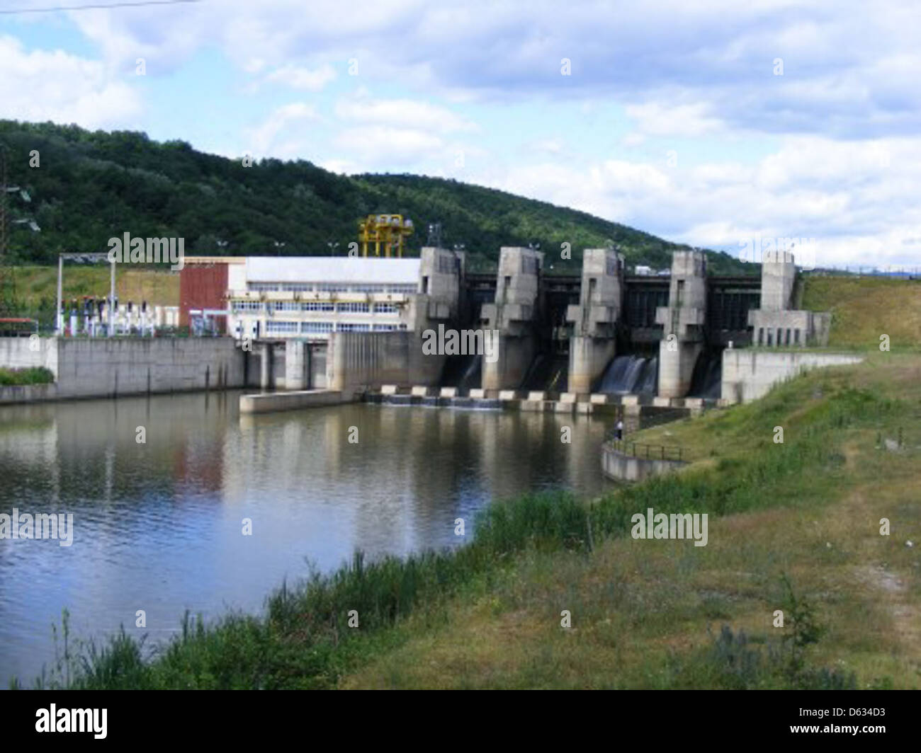 The image depicts a hydro-power plant in operation, where the natural ...