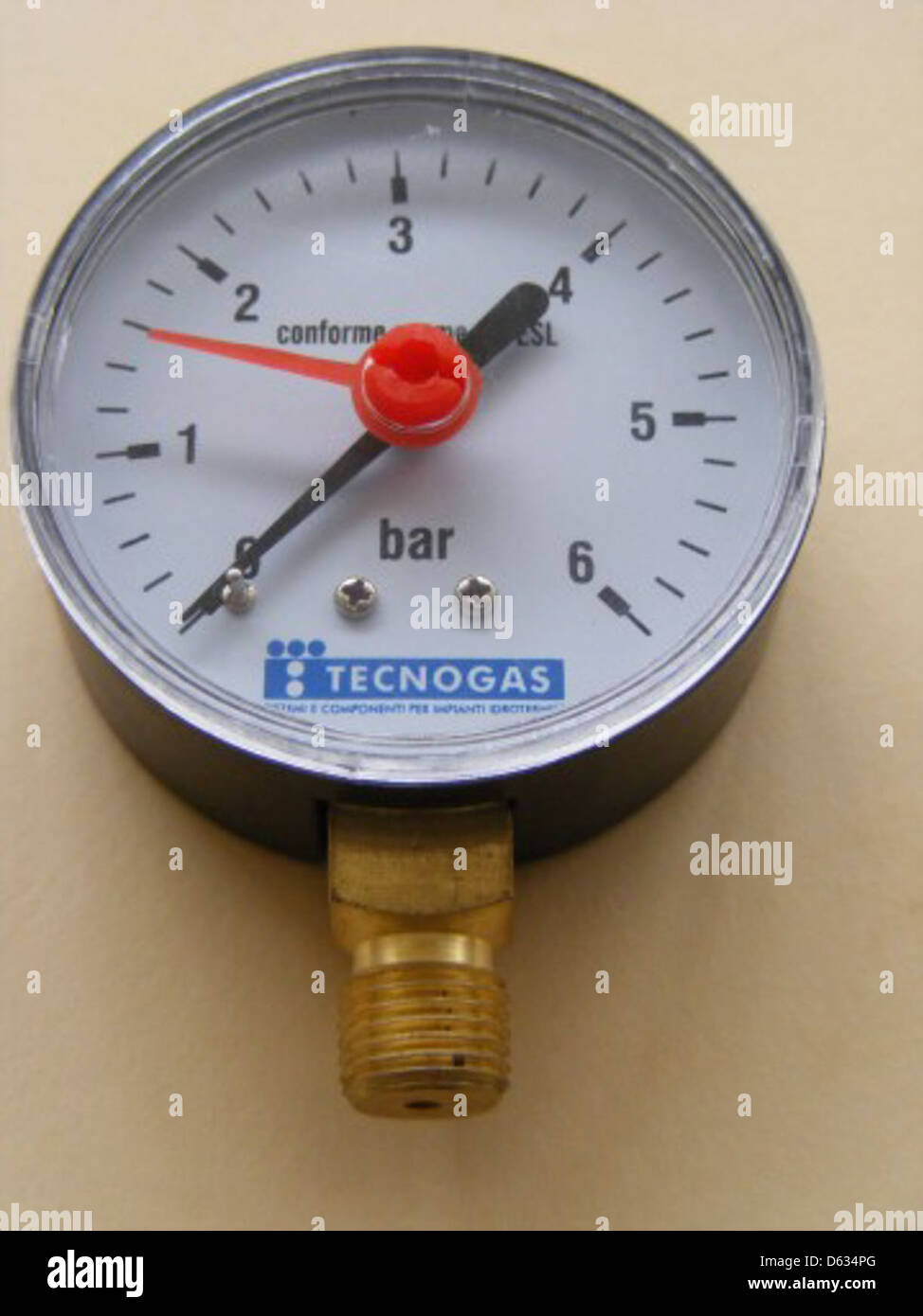 A close-up view of a round pressure gauge used in industrial settings ...