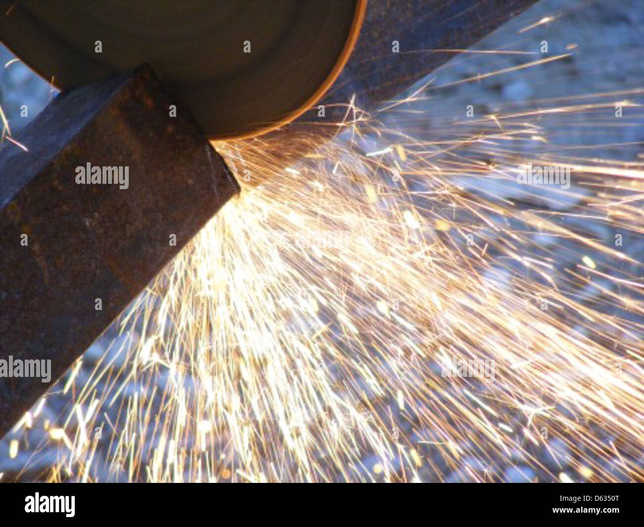 An image of sparks flying from an angle grinder in use. The tool is ...
