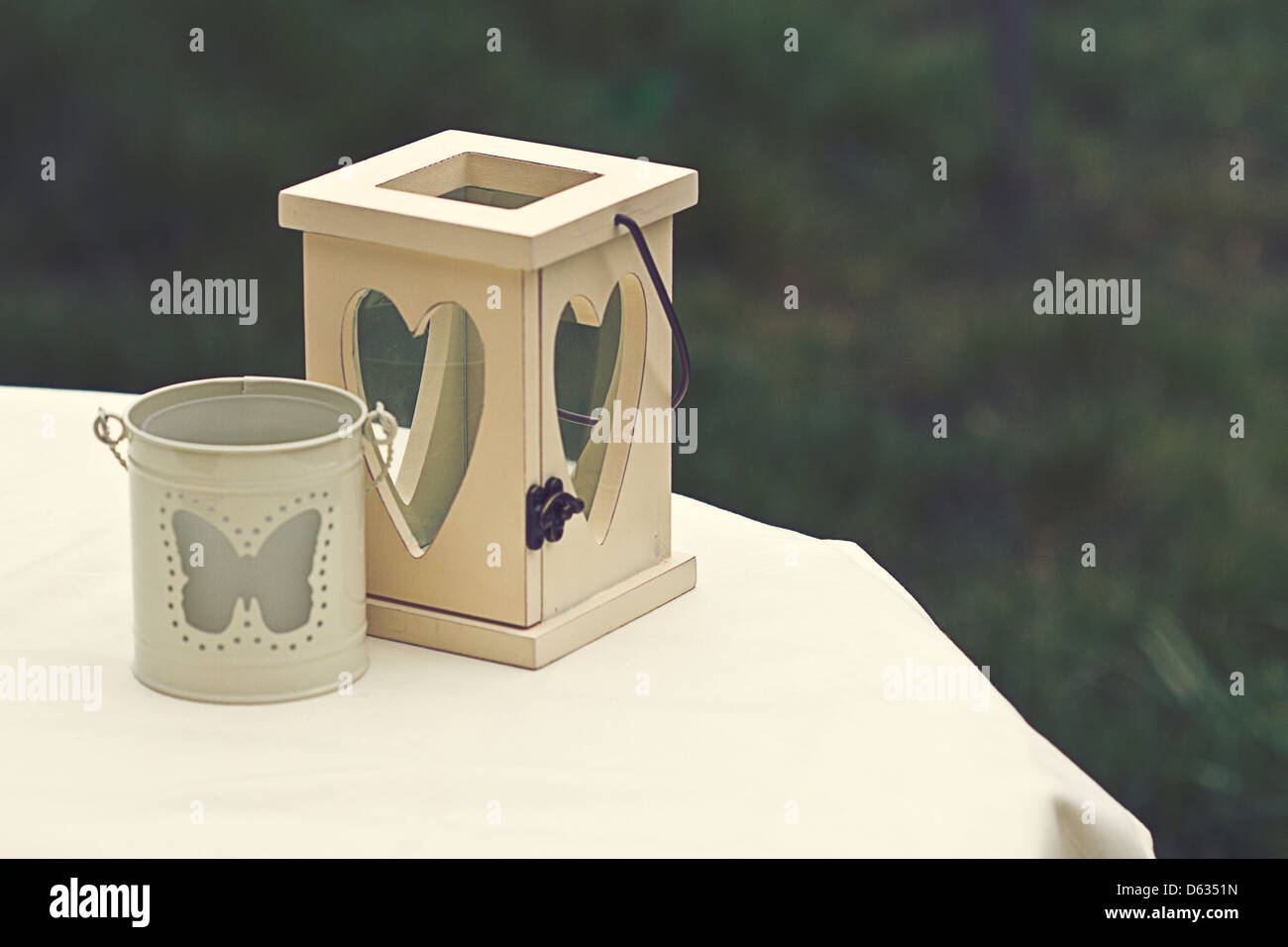 A photograph of two lanterns on a table outside Stock Photo - Alamy