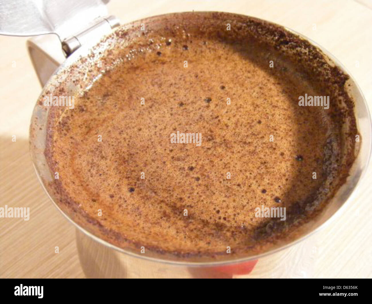 A close-up image of coffee foam with a rich texture, capturing the ...