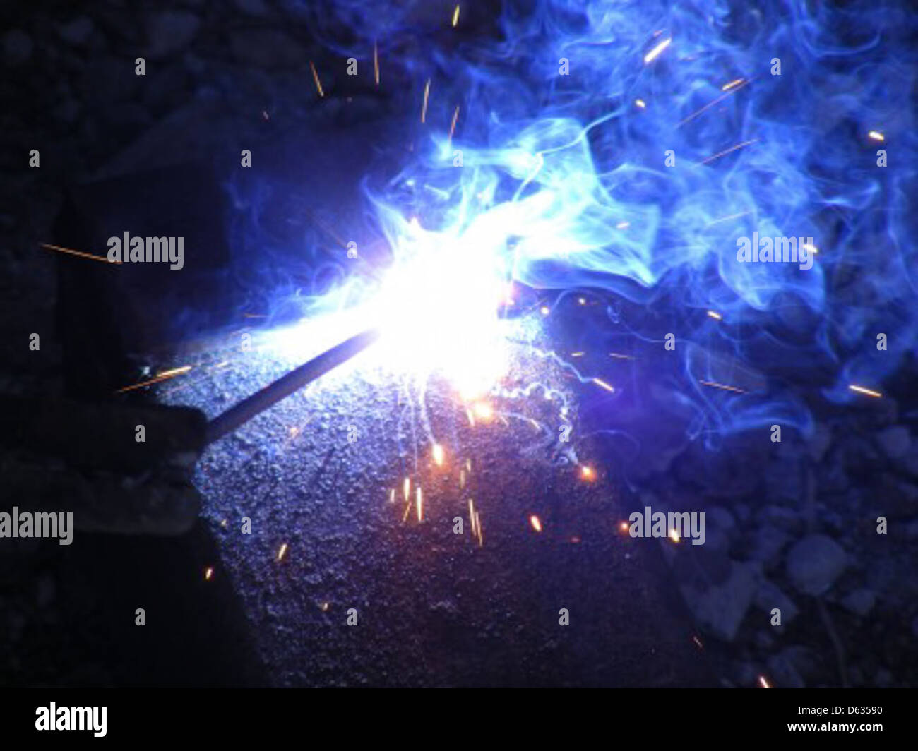 This image shows shielded metal arc welding in action, with the bright ...