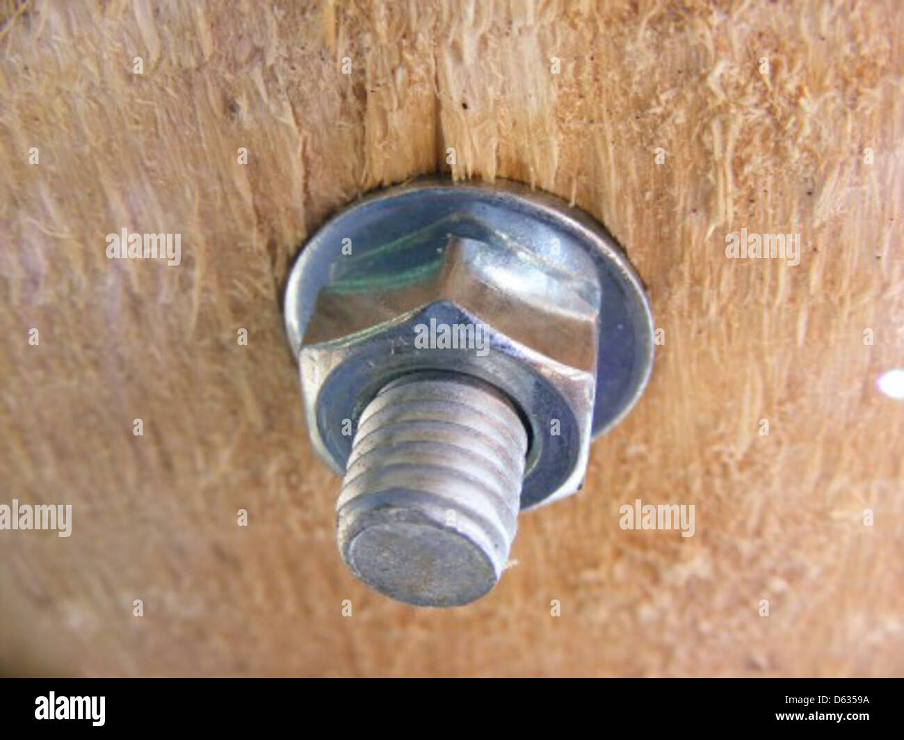 A close-up of a metal bolt and nut fastened together, demonstrating a ...