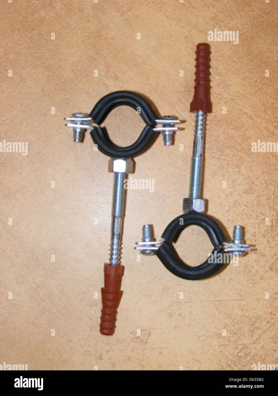 The image features pipe clamps with rubber inserts, commonly used to ...