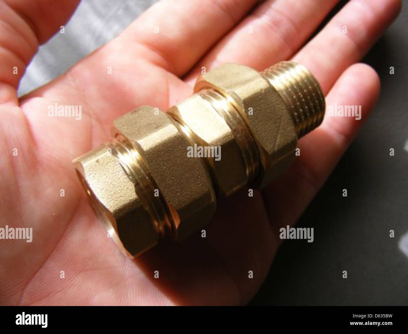 A brass screwed fitting union, designed for joining pipes and tubes in ...