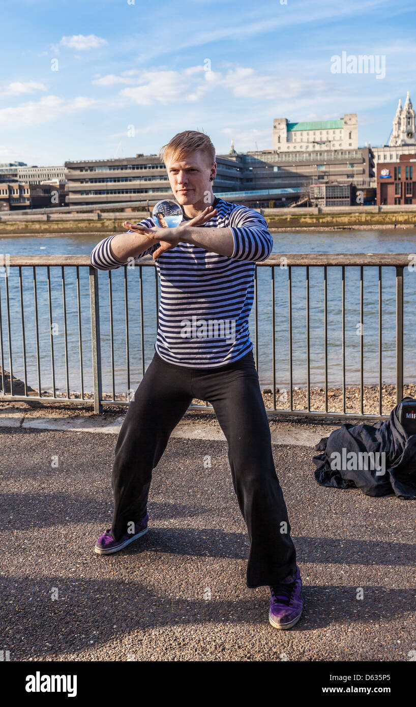 Street performer juggling with a crystal orb on The River Thames ...