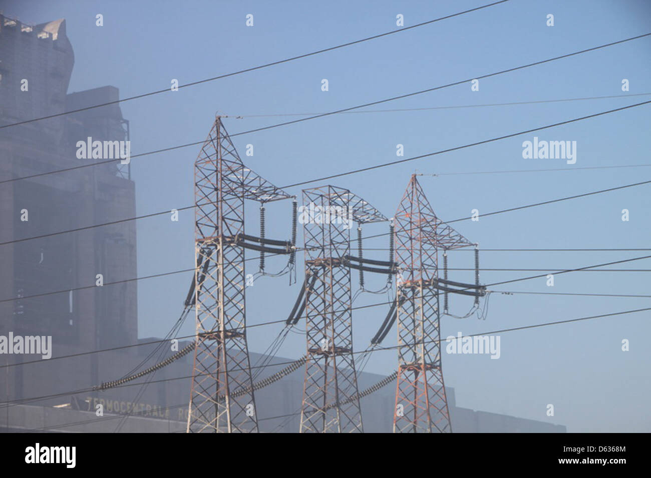 The image shows electric power poles, likely part of an energy ...