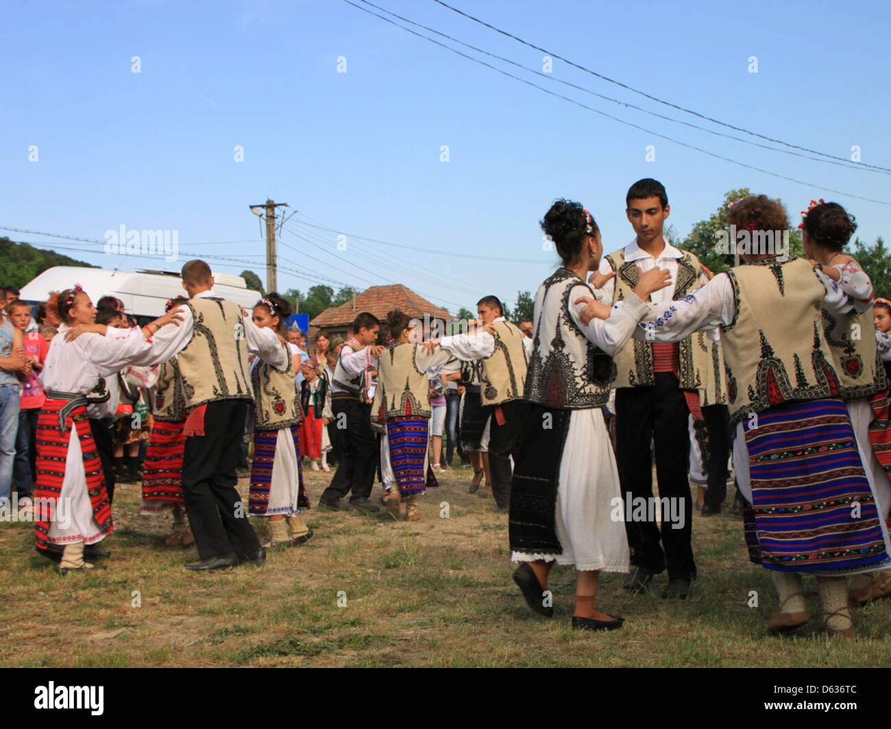 A group of young people participating in a folk dance, performing in ...