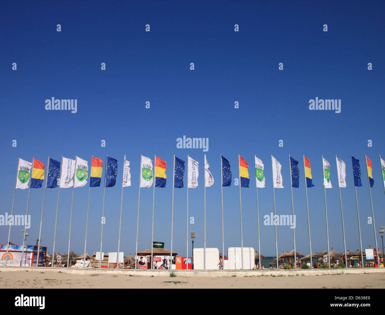 This image features various national flags waving in the wind. The ...