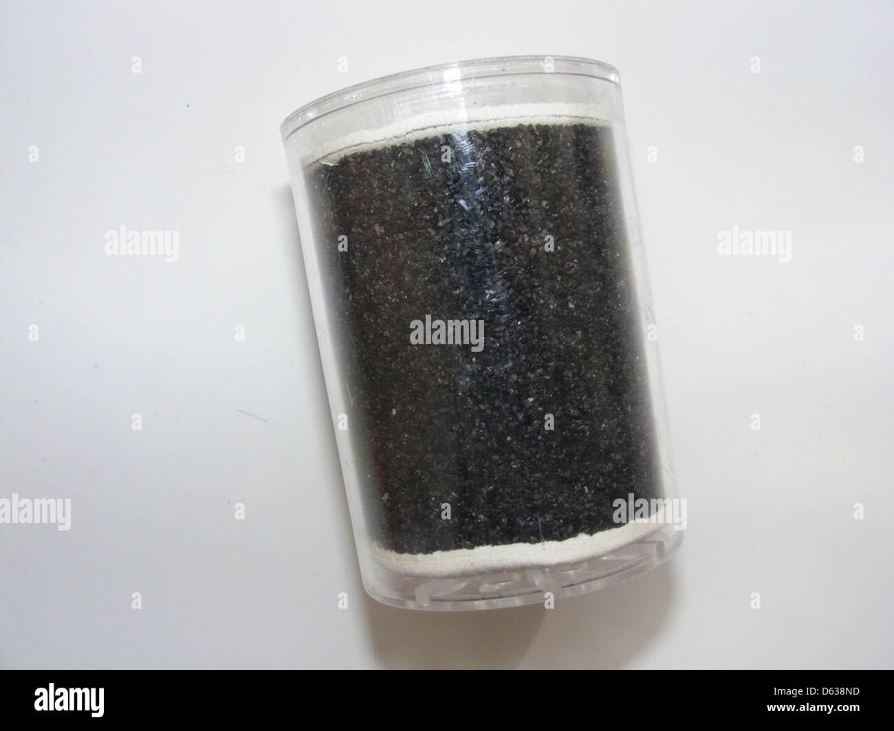 A black activated carbon water filter cartridge designed for purifying ...