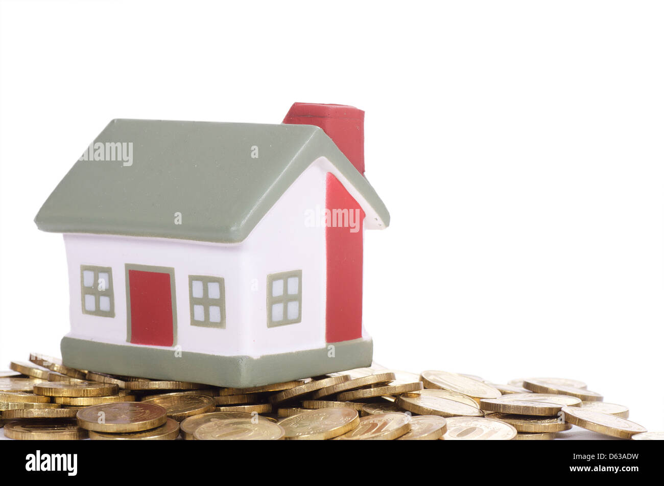Toy small house and coins Stock Photo - Alamy