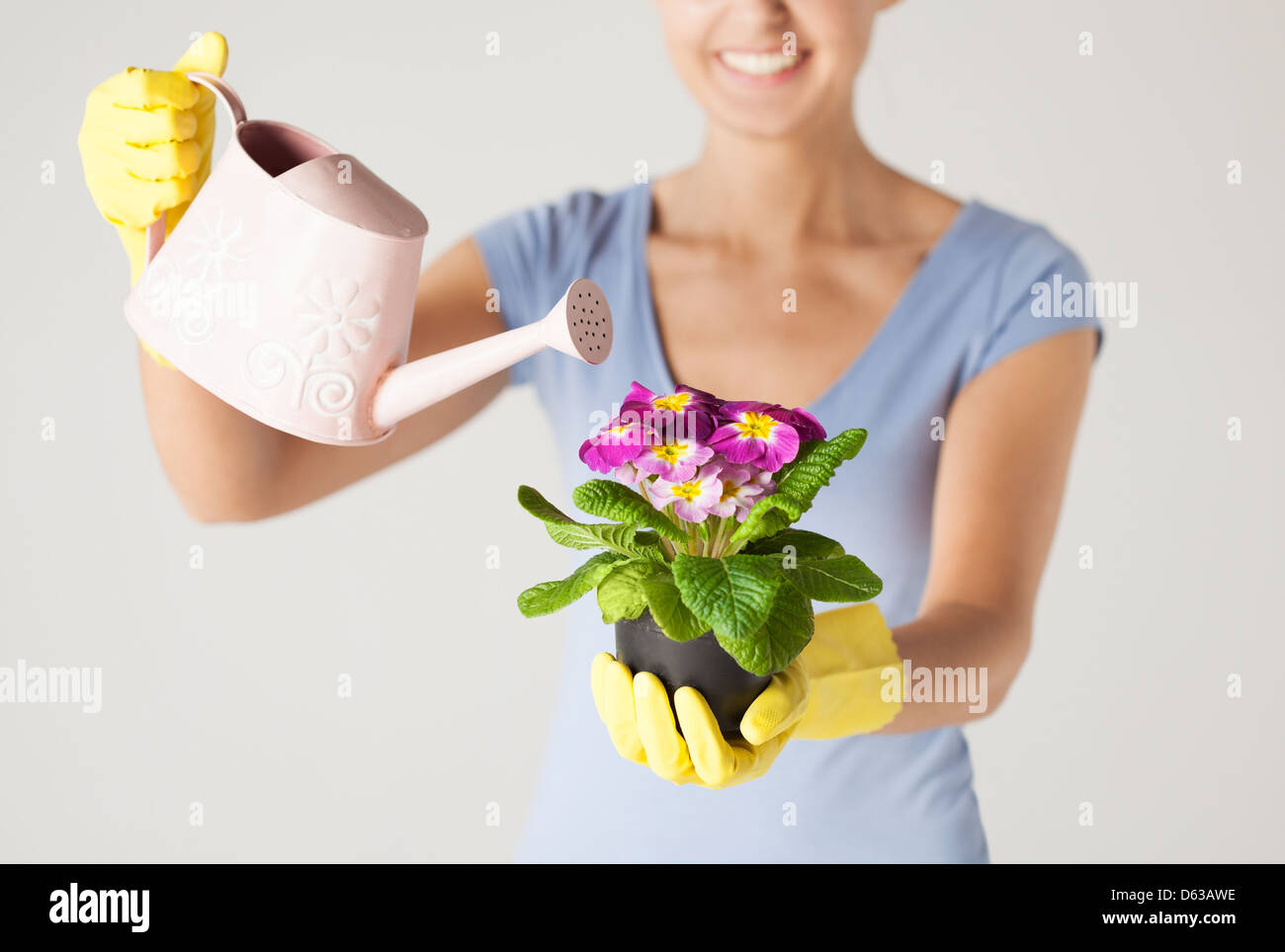 woman holding pot with flower Stock Photo - Alamy