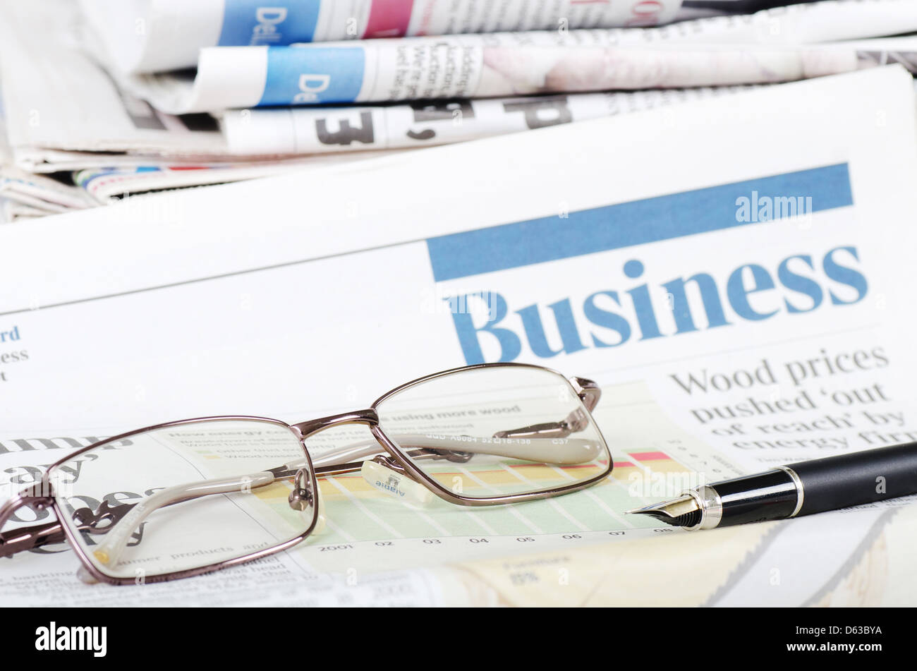 Business the newspaper with chart Stock Photo - Alamy