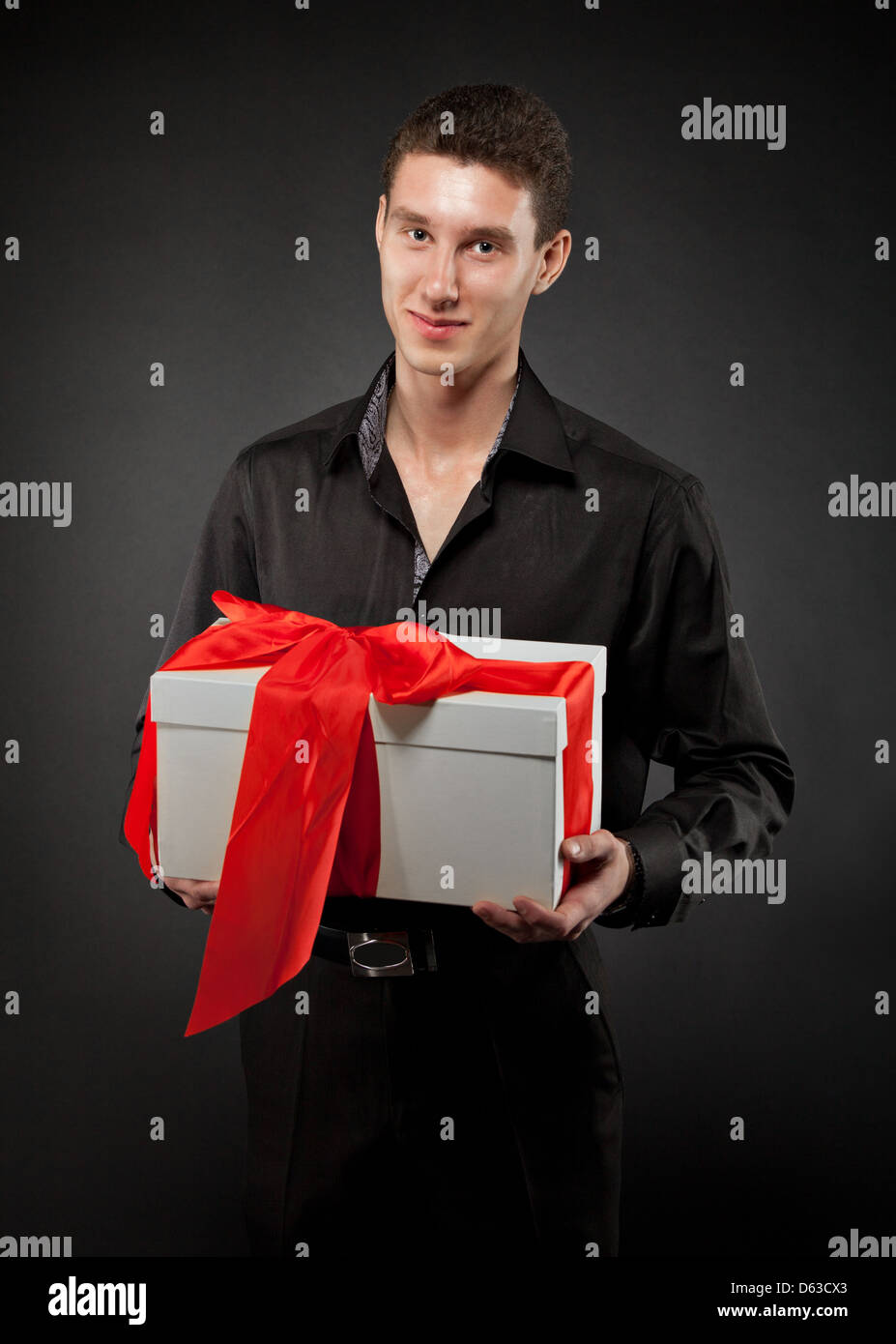 Happy young man with present Stock Photo - Alamy