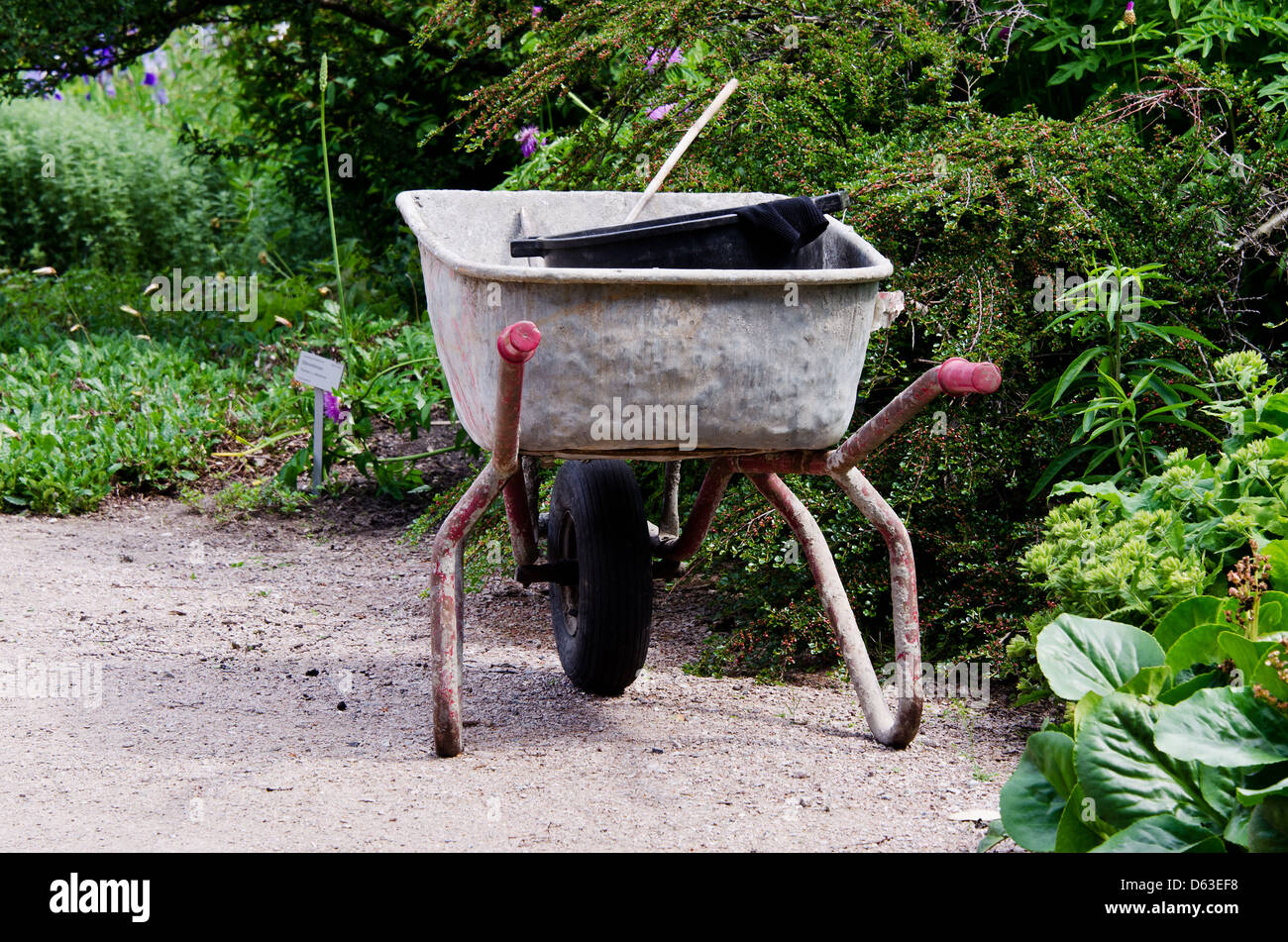 Gardening wheelbarrow with tool Stock Photo - Alamy