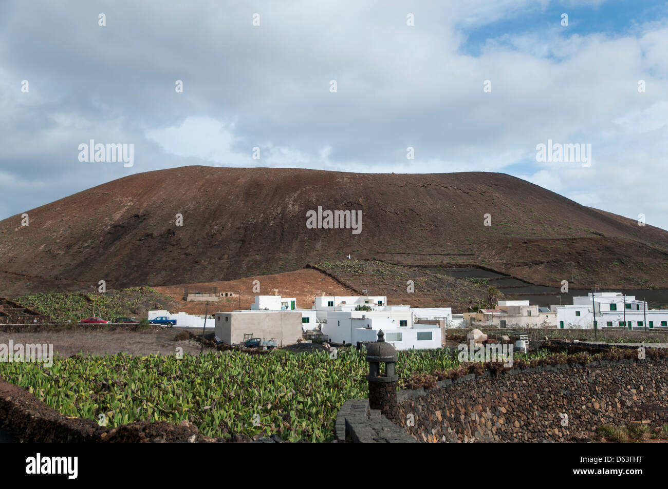 volcanic landscape with a volcano and the houses down Stock Photo - Alamy