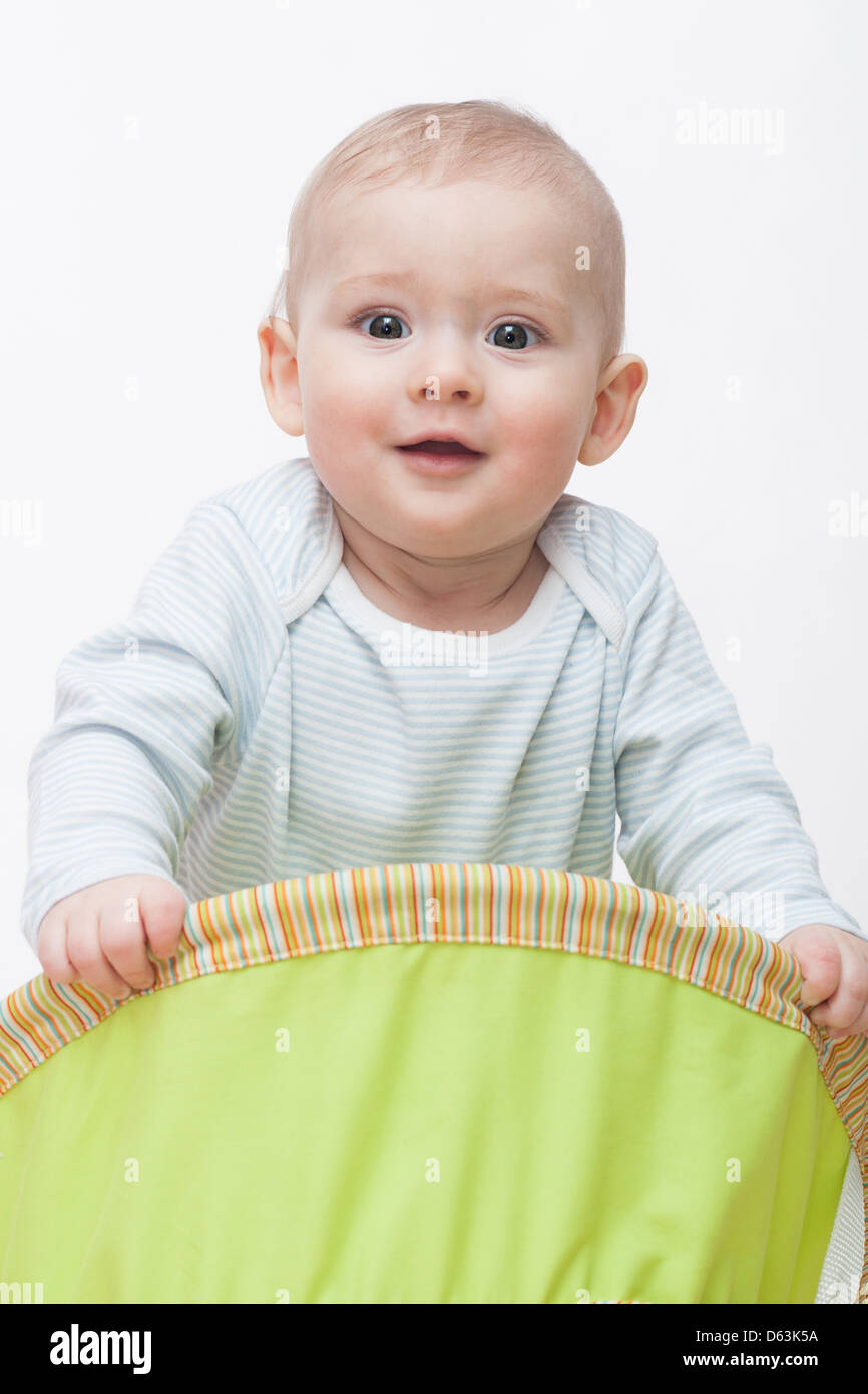 Baby boy learning to stand up Stock Photo - Alamy