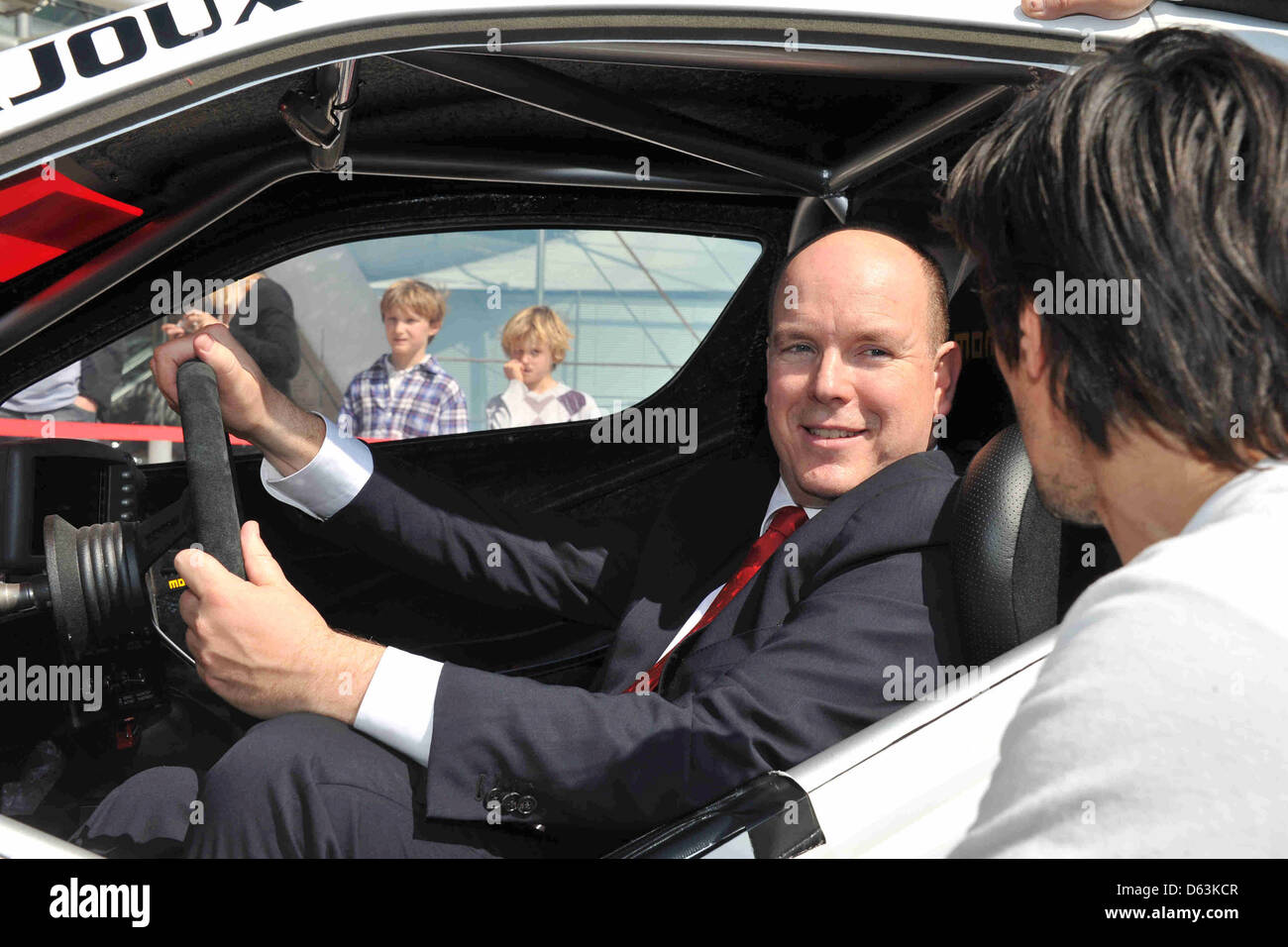 Prince Albert II of Monaco is presented an electric race car during the ...