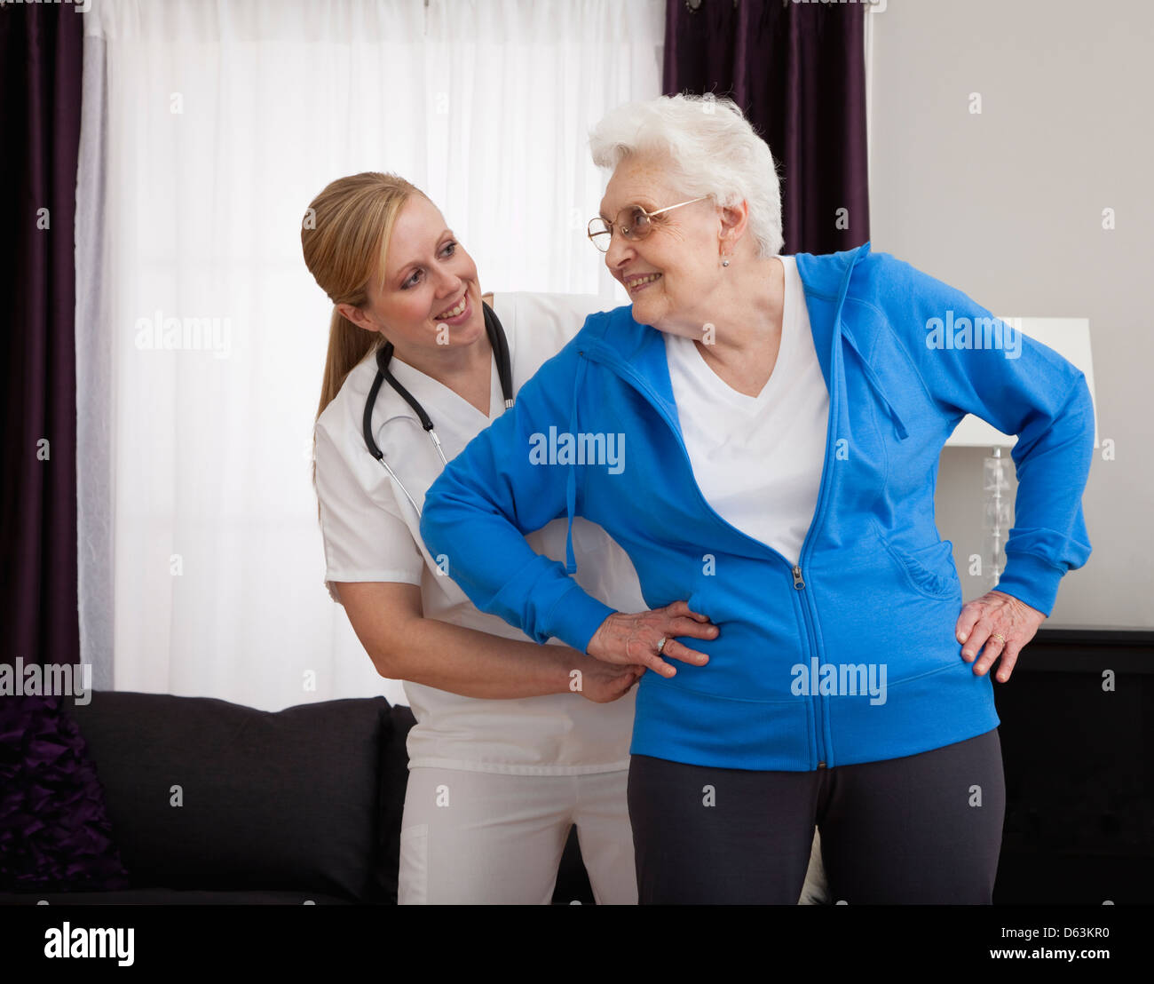 Senior woman exercising with nurse Stock Photo - Alamy
