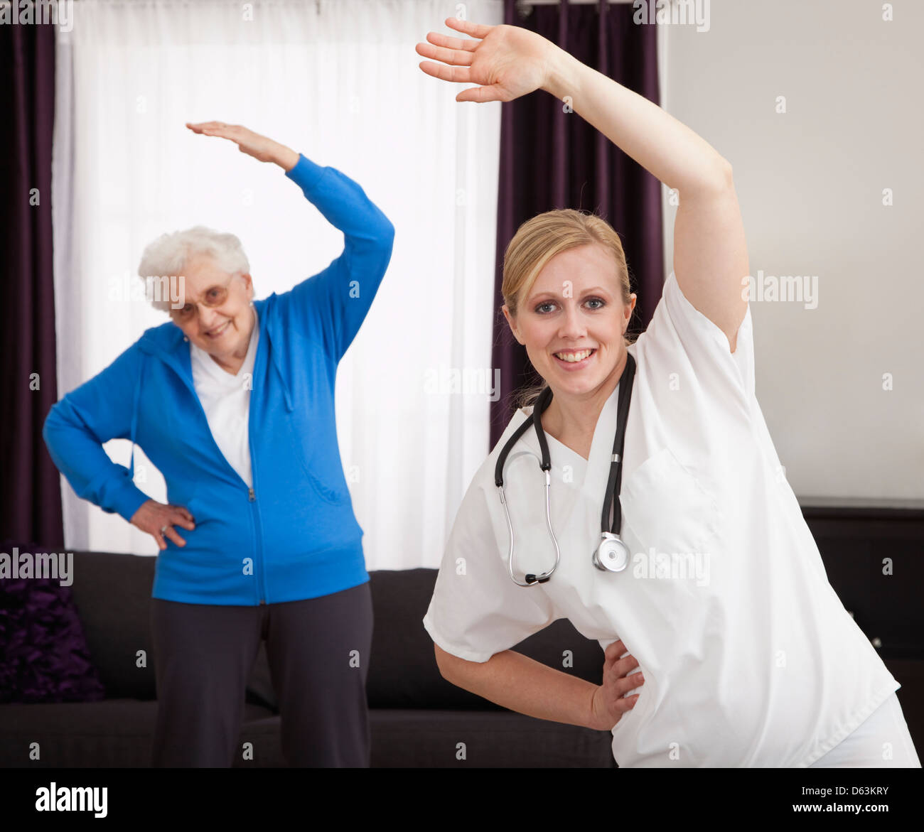 Senior woman exercising with nurse Stock Photo - Alamy