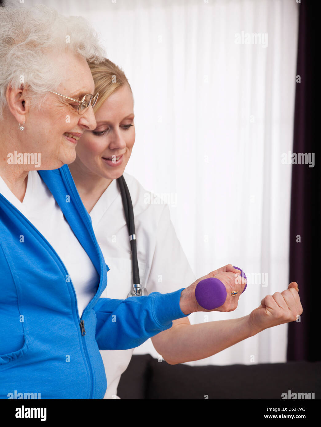 Senior woman exercising with nurse Stock Photo - Alamy