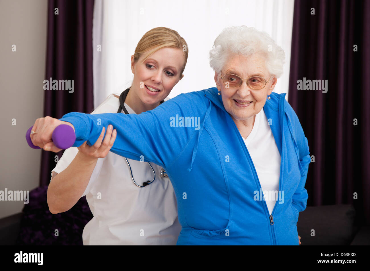 Senior woman exercising with nurse Stock Photo - Alamy